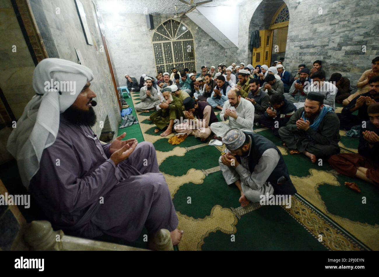 Peshawar, Pakistan. 30th Mar, 2023. People are praying and eating rice ...