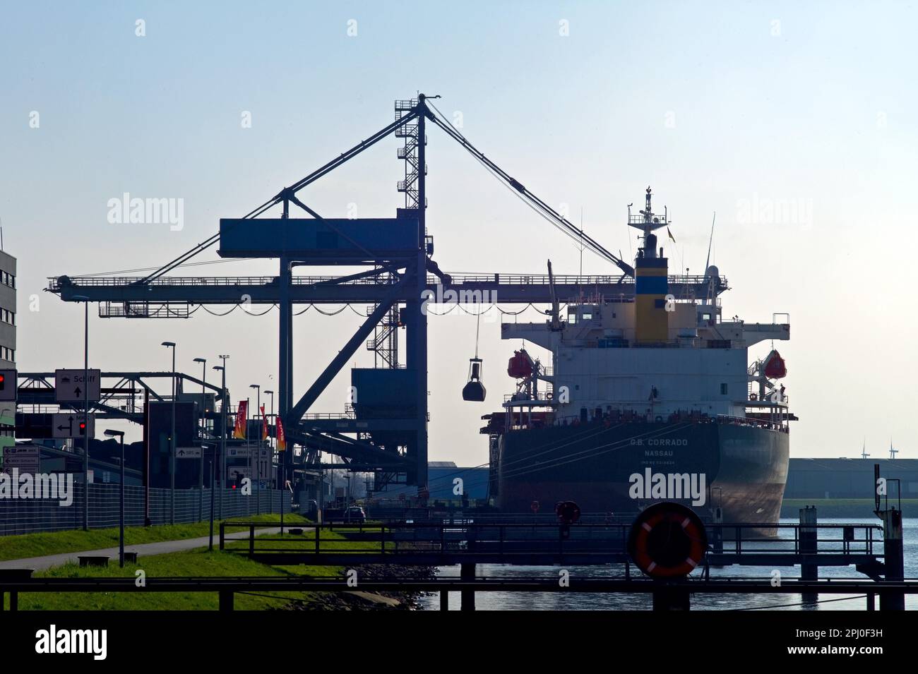 Cargo ship in the coal harbour unloading coal for the coal-fired power ...