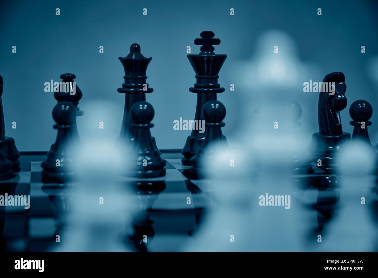Black chess pieces background white blurred chess pieces standing ...