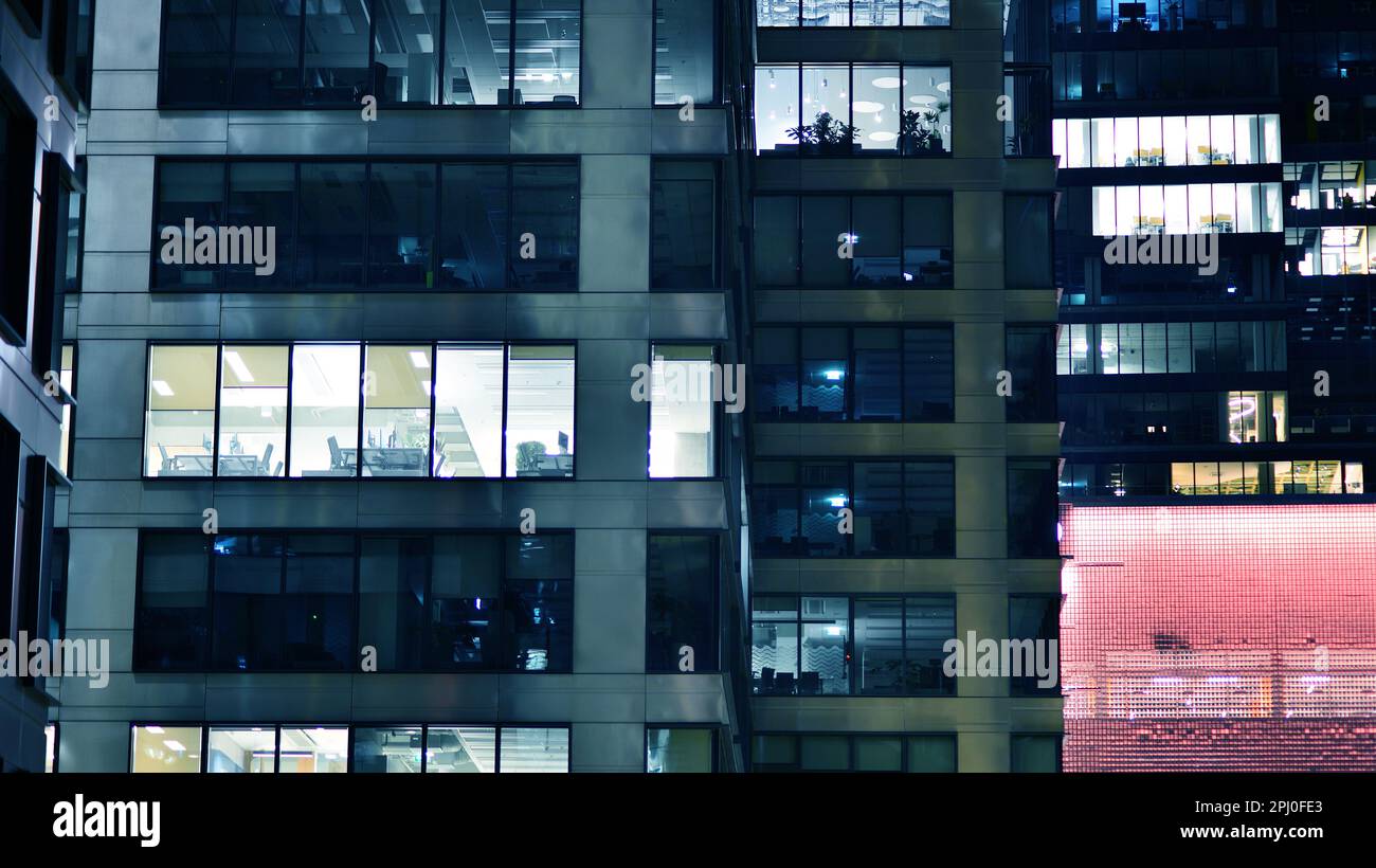 Pattern of office buildings windows illuminated at night. Glass ...