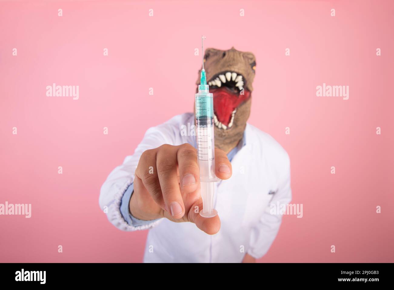 funny and surreal concept of doctor holding a syringe close-up, on an ...