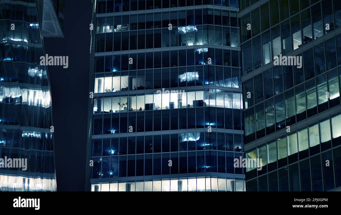 Pattern of office buildings windows illuminated at night. Glass ...