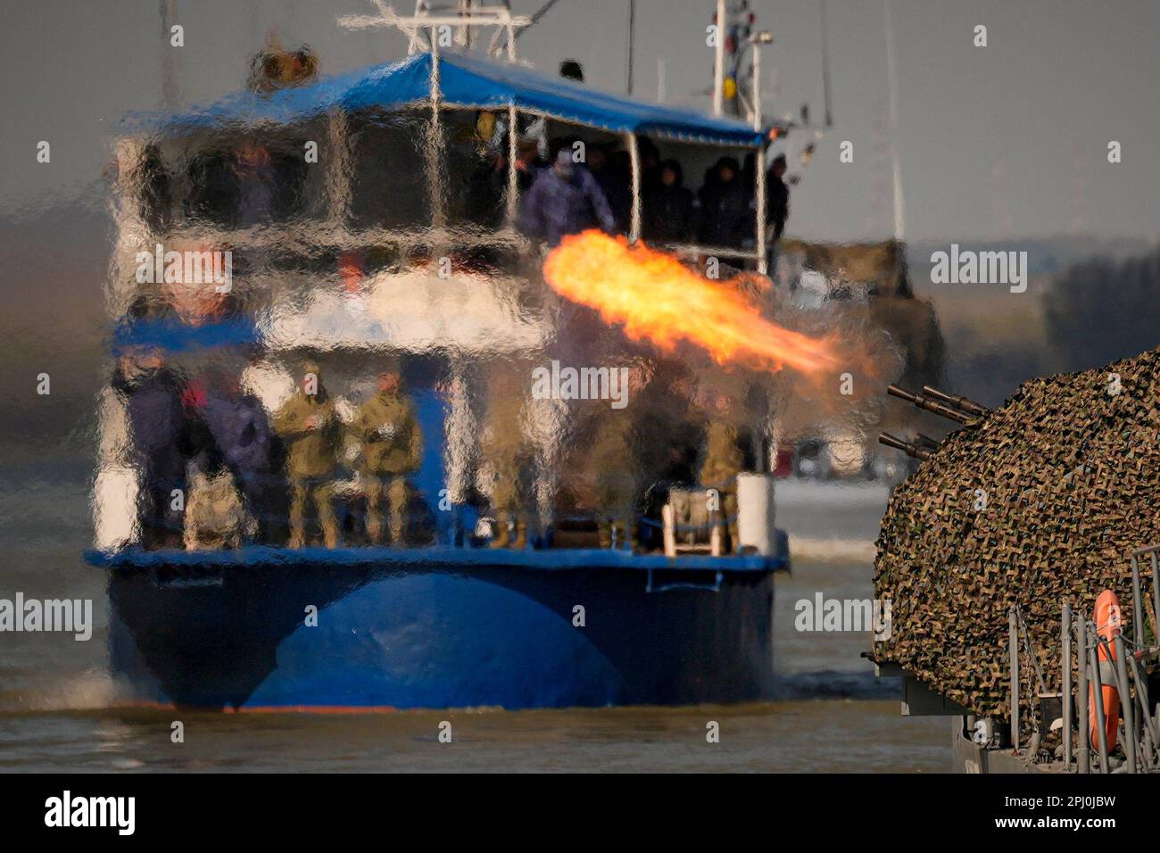 A command ship is seen through the haze from a firing heavy machine gun ...