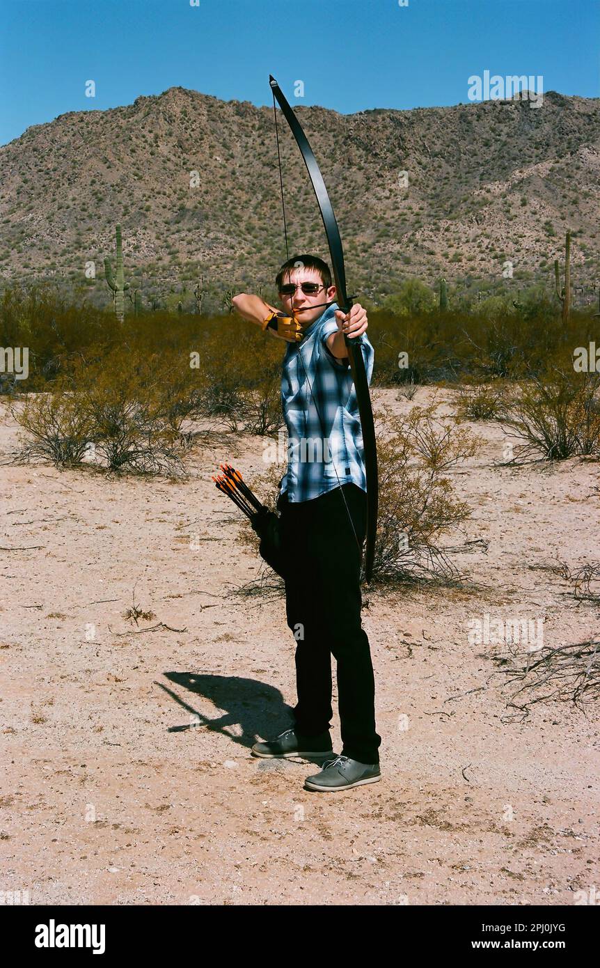 Young archer shooting a traditional long bow Stock Photo - Alamy