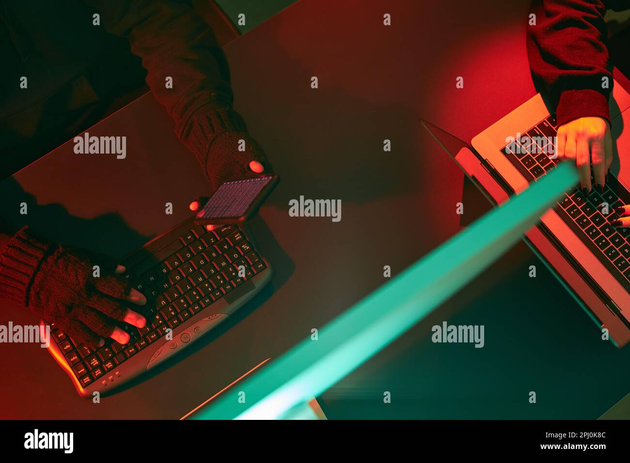 Anonymous people using computer and programming to break code. Cyber ...