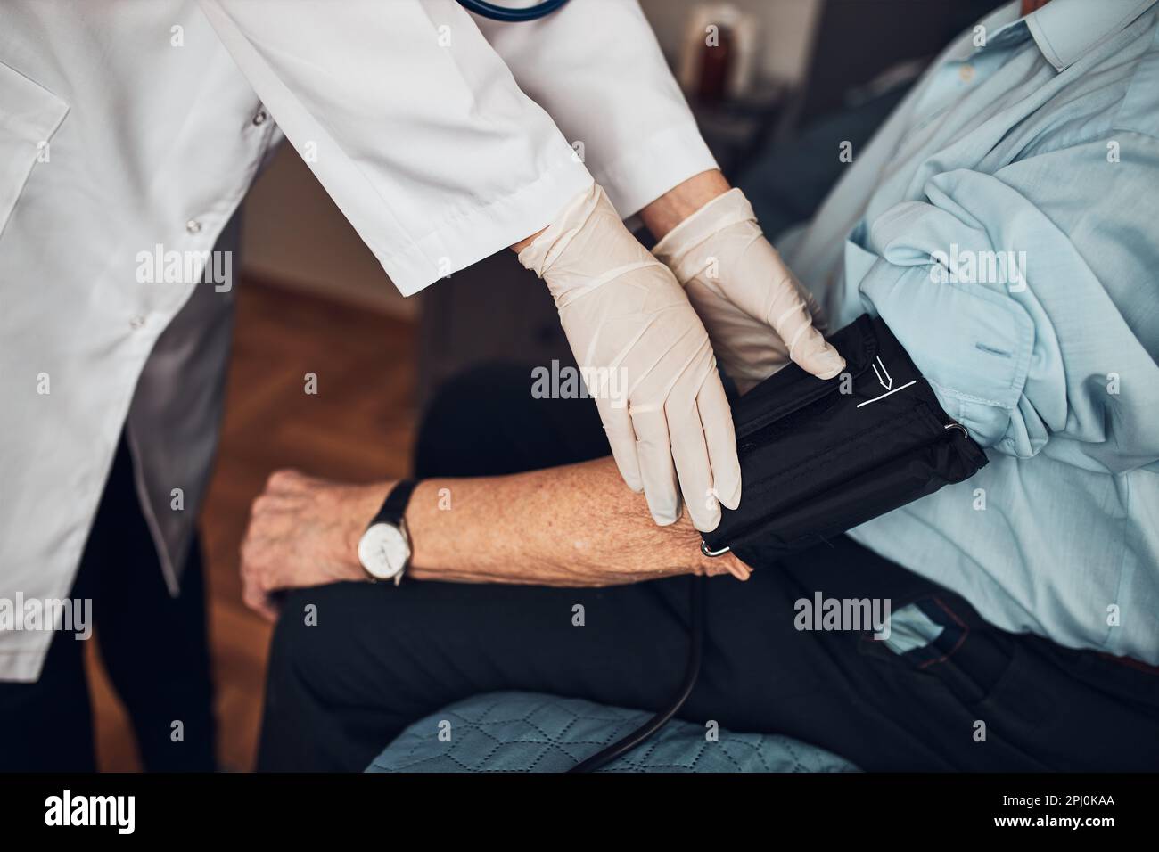 Doctor carying out blood pressure test and heart rate of senior man ...