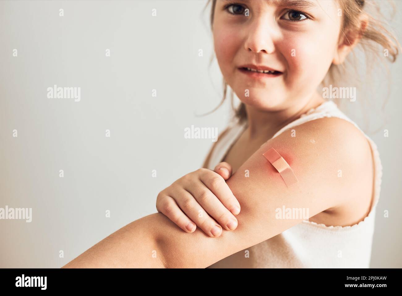 Little girl feeling pain having some side effects after vaccination ...