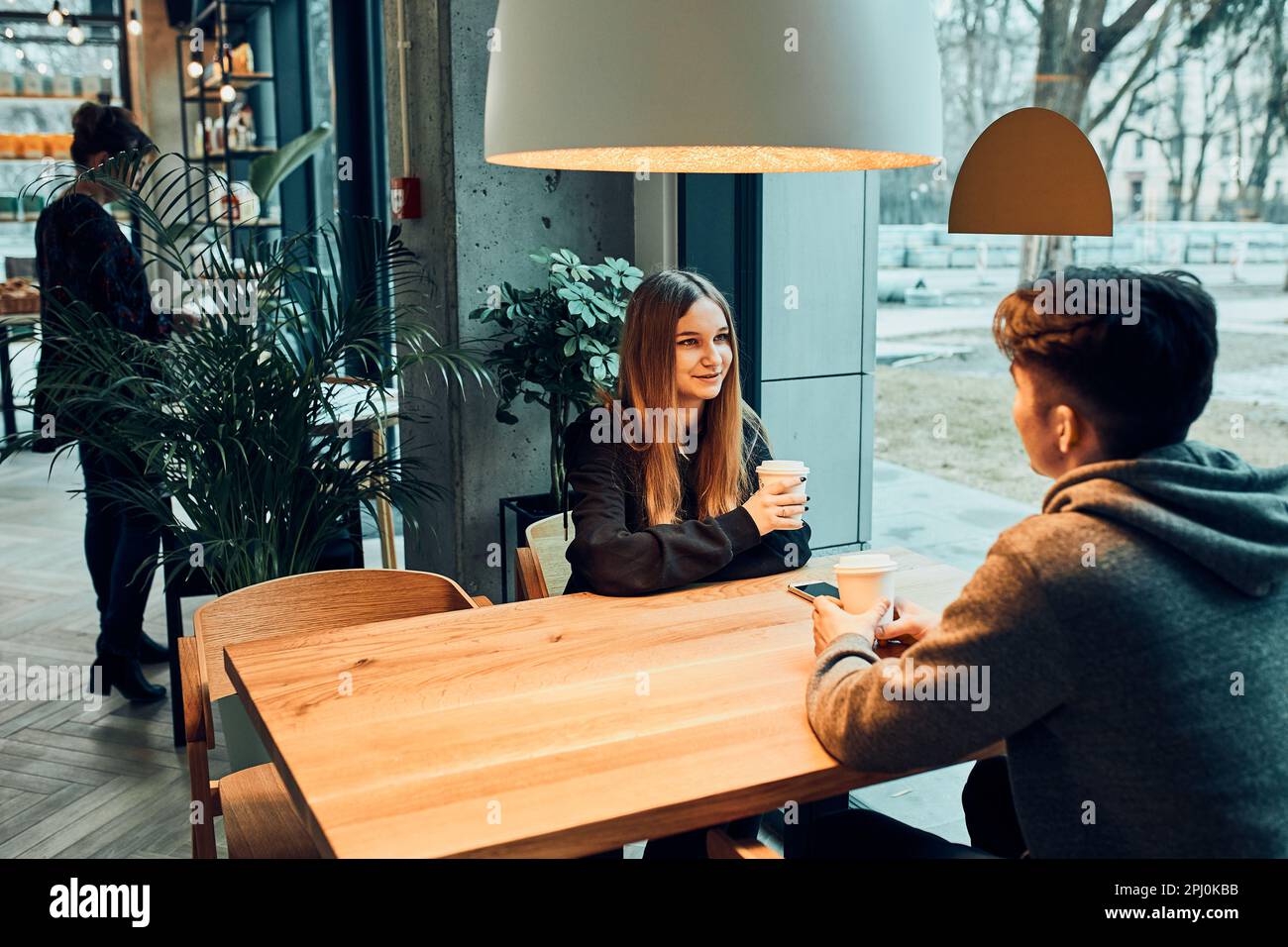 Friends having a chat, talking together, drinking coffee, sitting in a ...