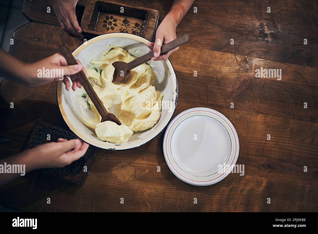 Female putting homemade butter to bowl. Old traditional method making ...