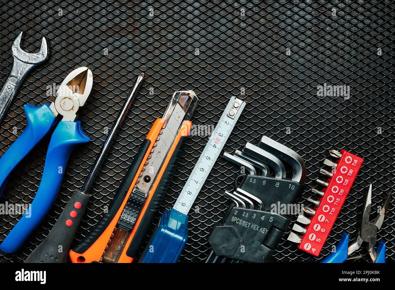 Hardware tools wrench screwdriver tape hammer on steel surface ...