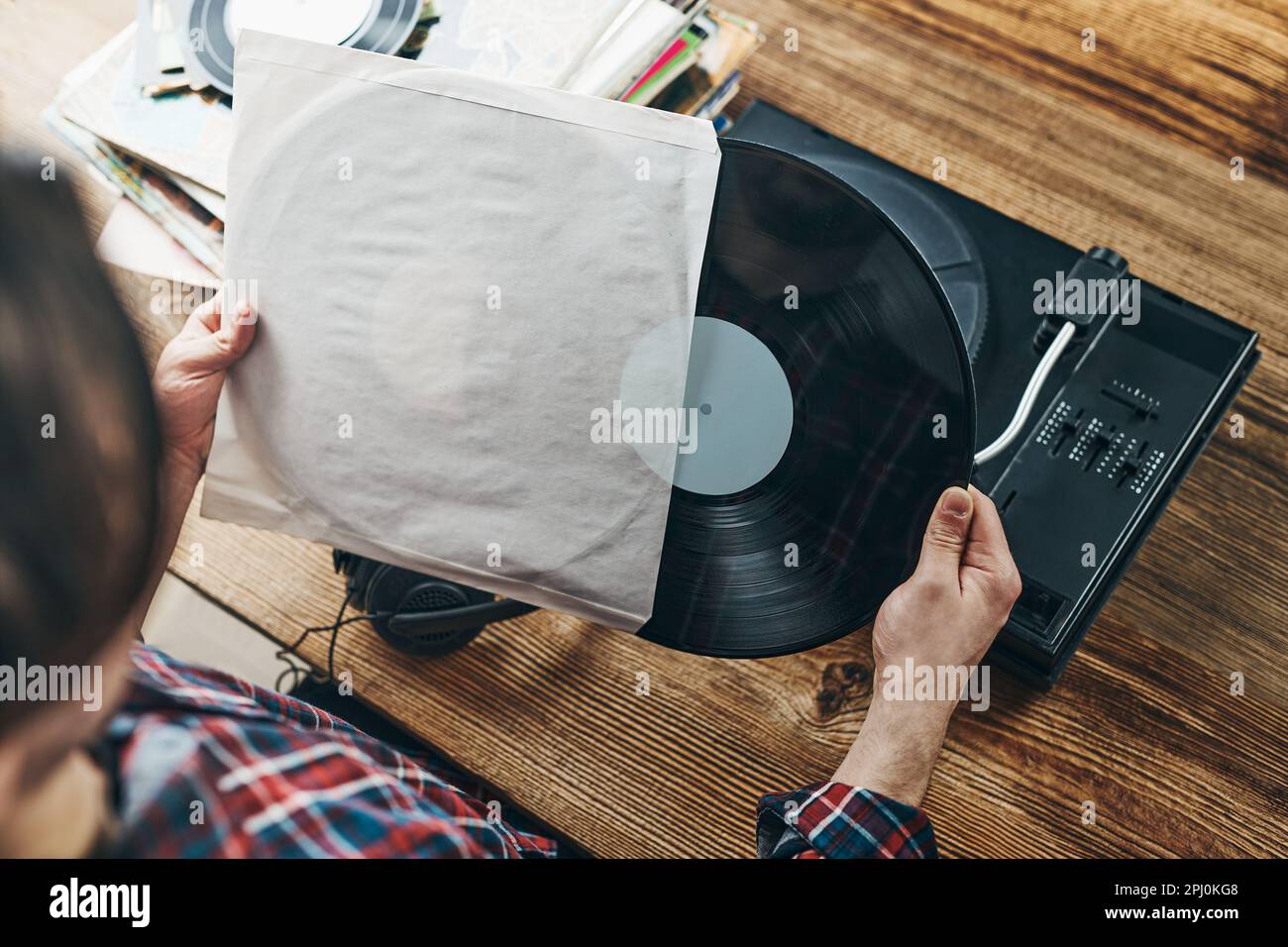 Man listening to music from vinyl record. Playing music from analog ...