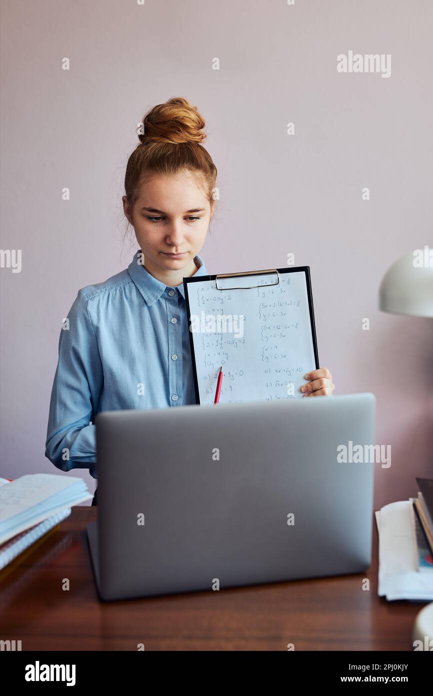 Young woman student showing homework, having classes, learning online ...