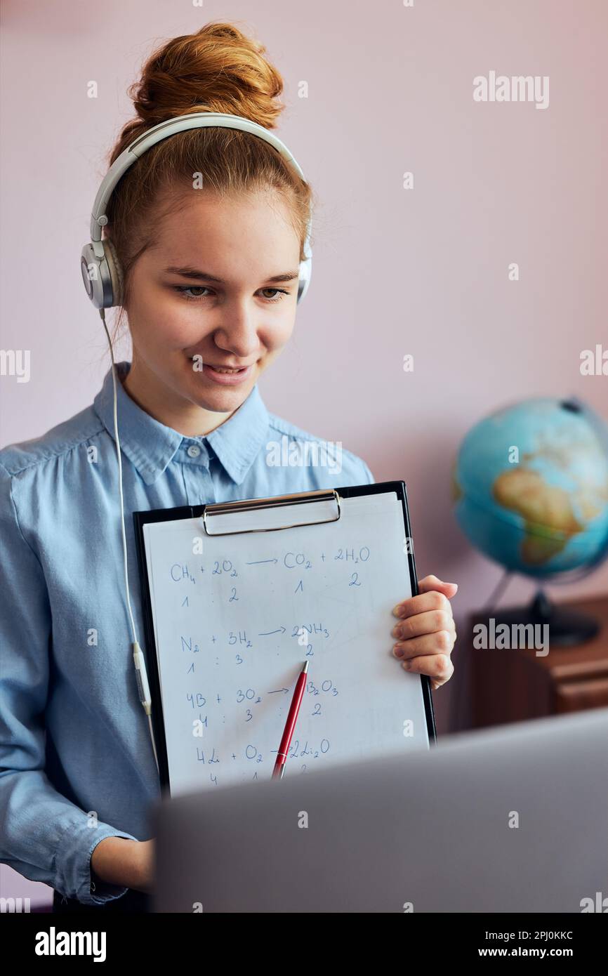 Young woman student showing homework, having classes, learning online ...