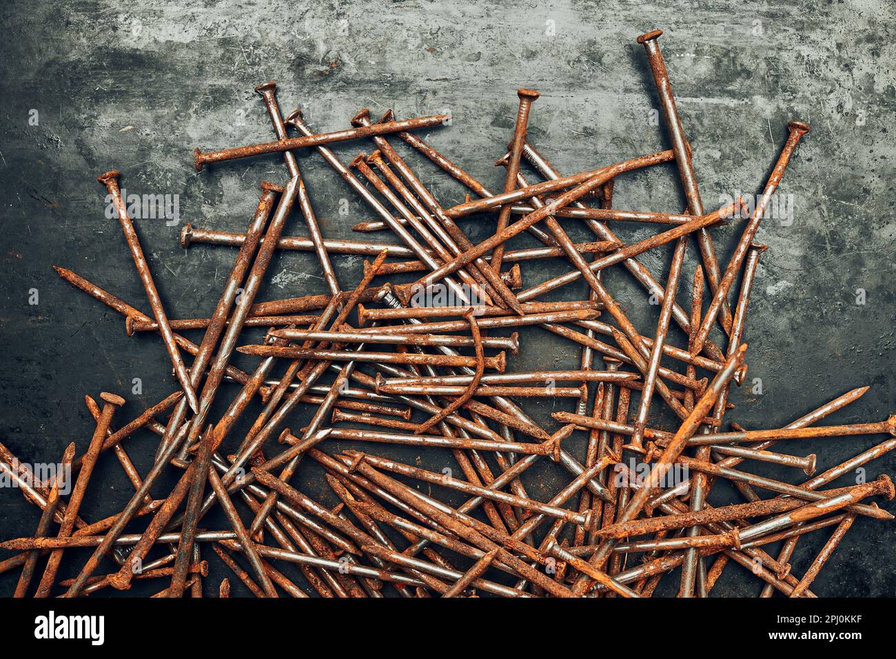 Rusty nails on steel surface. Tools for maintenance. Hardware tools to ...