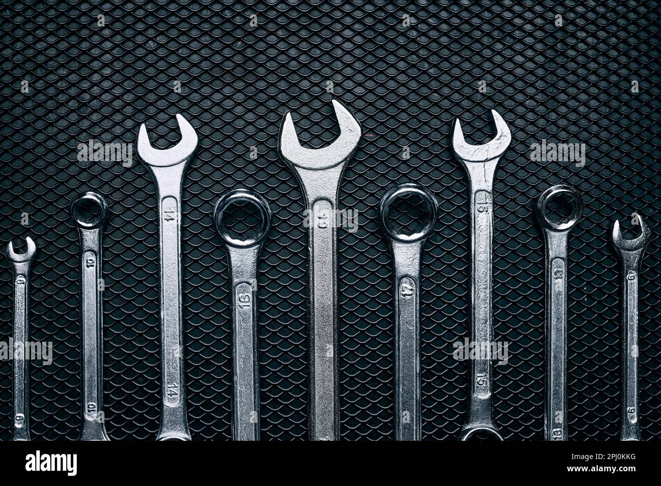 Set of chrome wrenches on steel surface. Mechanic tools for maintenance ...