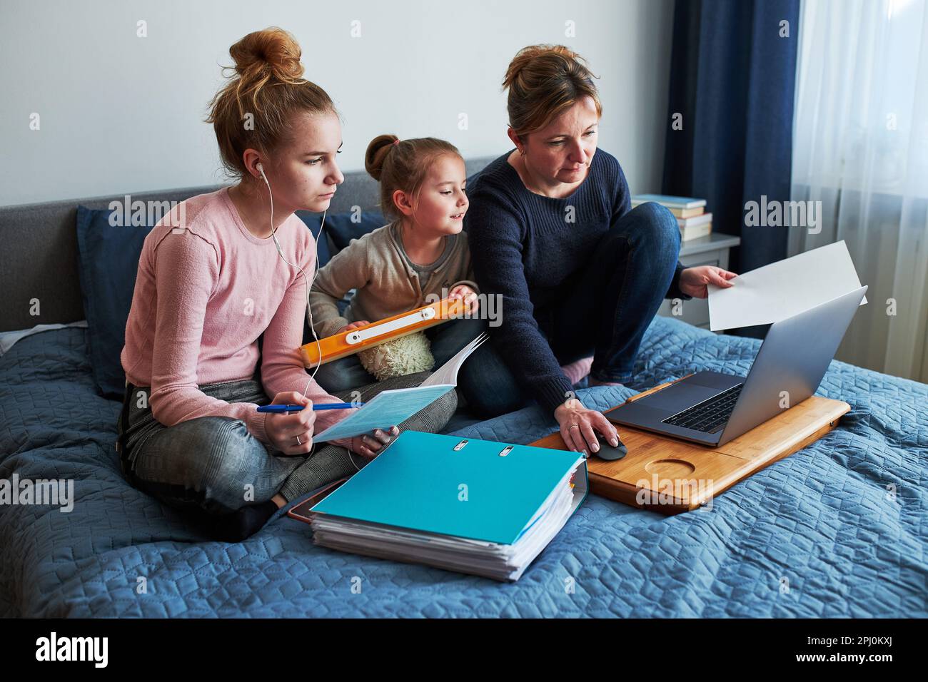 Women mother and daughter working learning remotely doing job homework ...