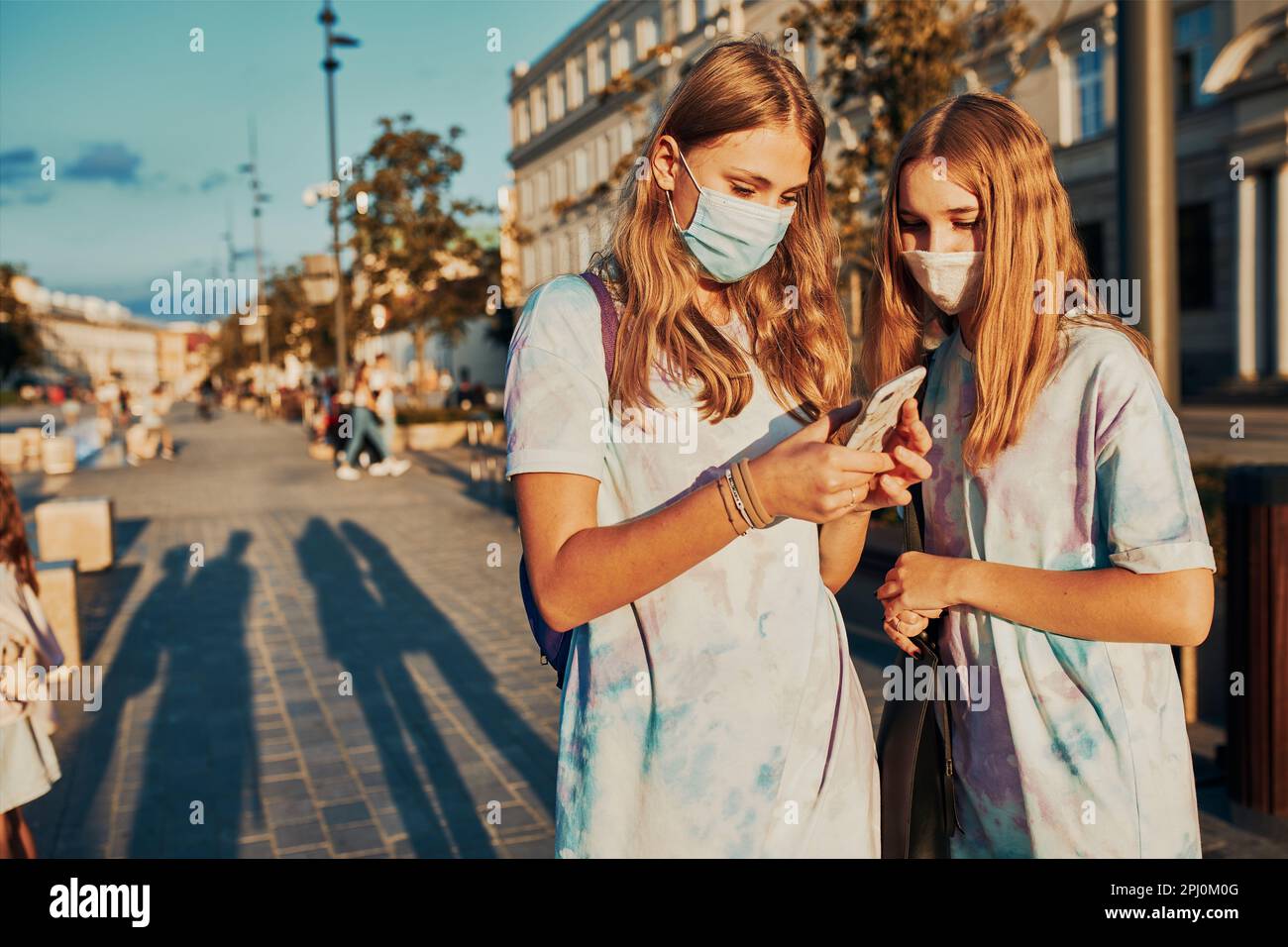 Young women girls using smartphones using social media sending texts ...