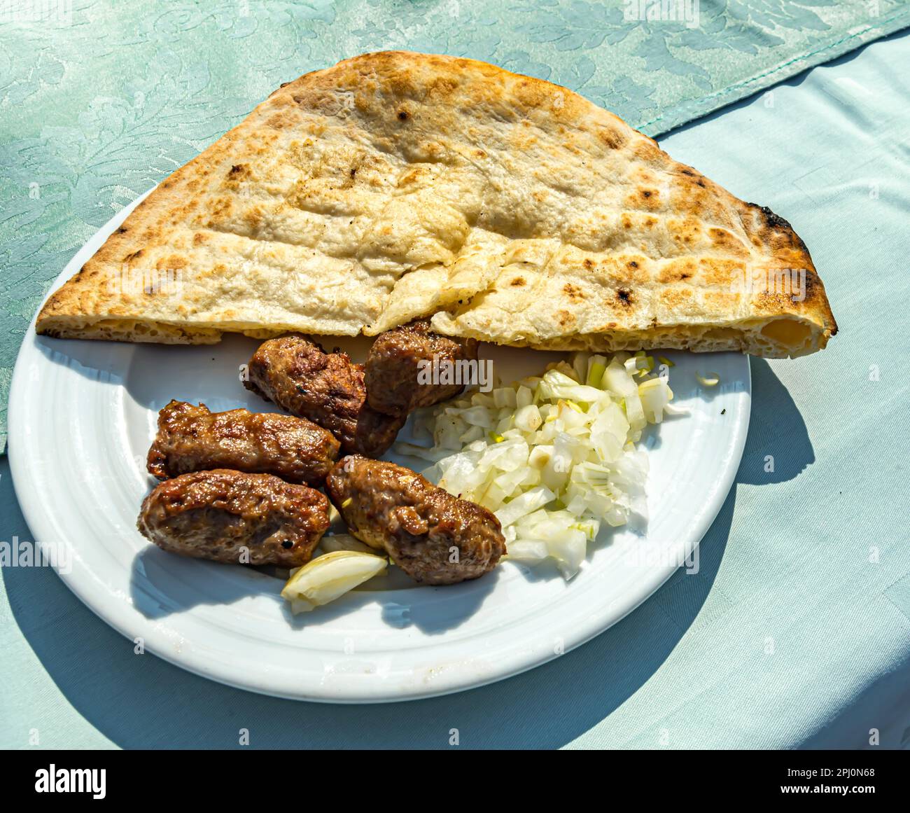 Cevap with somun is traditional Bosnian food Stock Photo - Alamy