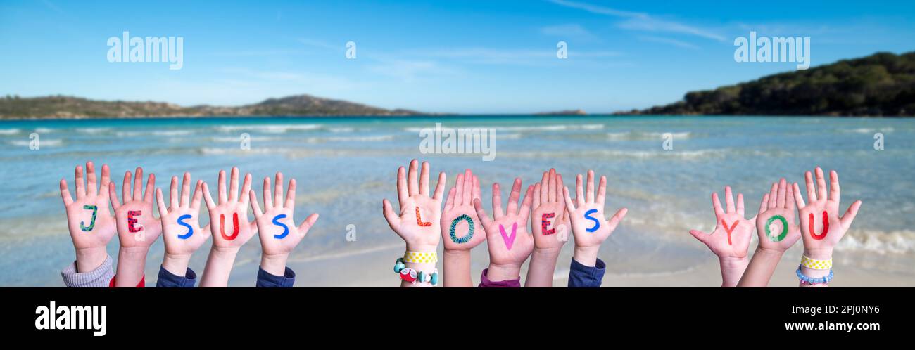 Children Hands Building Word Jesus Loves You, Ocean And Sea Stock Photo ...