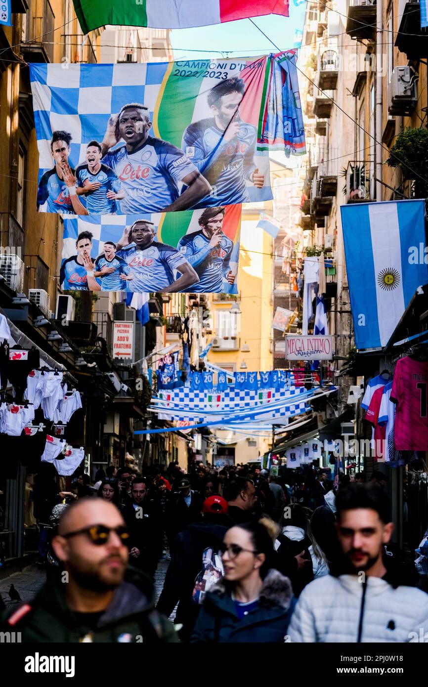 People pass under Banners and ribbons with the colors of the SSC Napoli ...