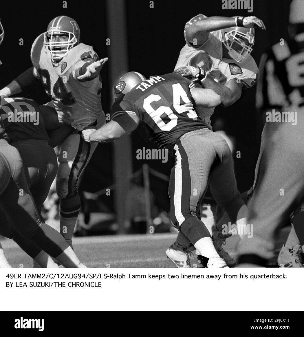 49ER TAMM2/C/12AUG94/SP/LS-Ralph Tamm keeps two linemen away from his ...