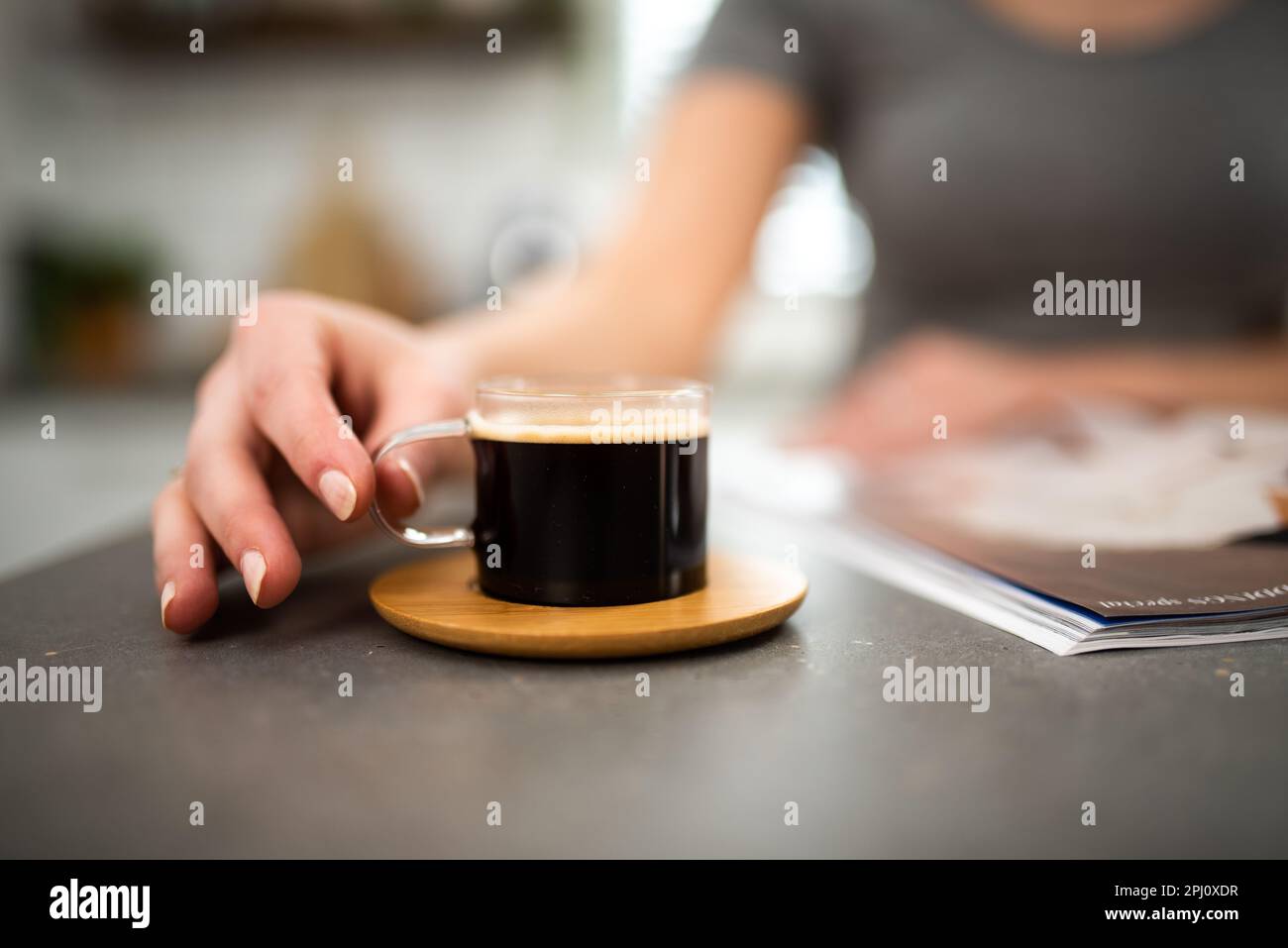 Closeup of woman reading magazine whilst drinking coffee Stock Photo ...