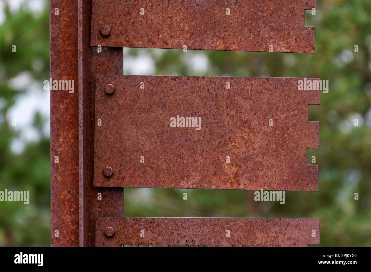 Empty rusty sign close up with green nature background Stock Photo - Alamy