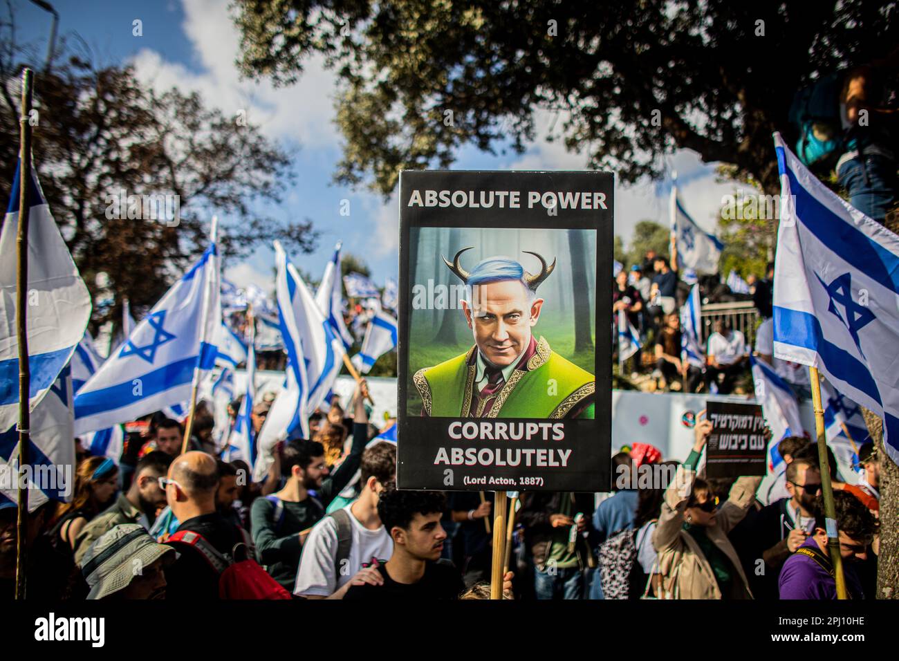Anti reform protesters wave flags and hold a portrait of Israeli Prime ...