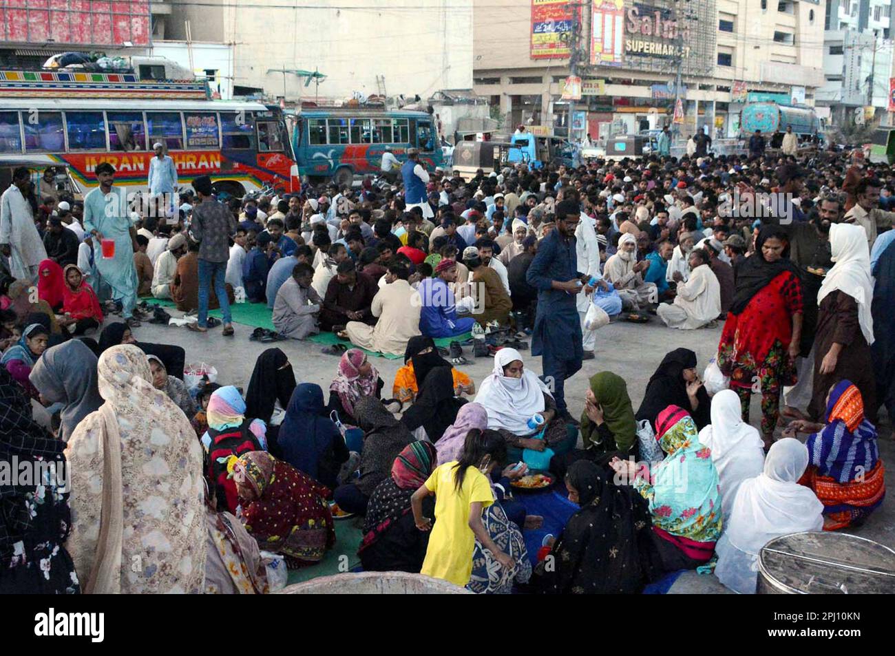 Faithful Muslims are breaking the fast (Iftar) at roadside stall during ...