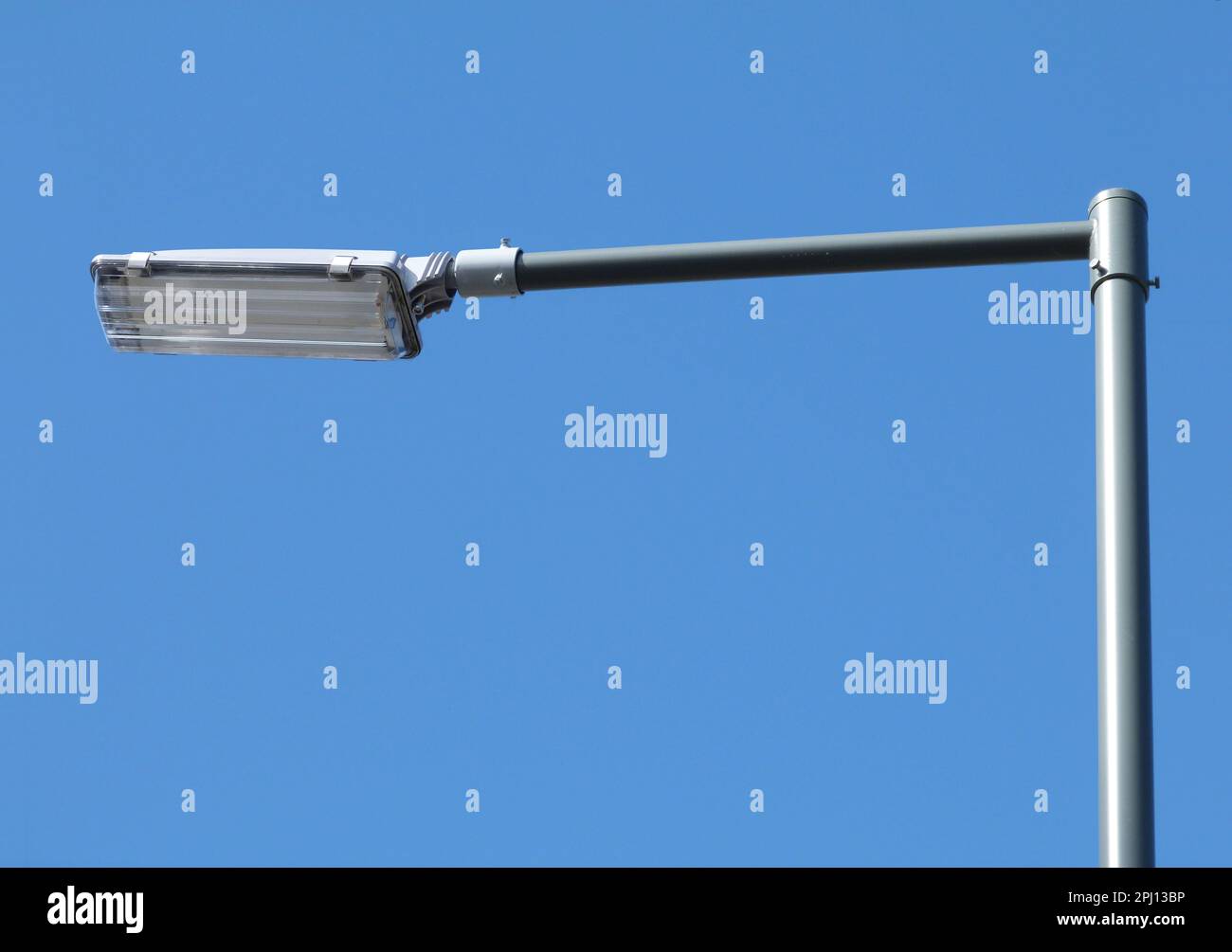 modern street lamp with square head under blue sky in perspective view ...