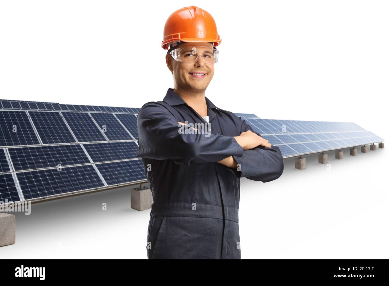 Factory worker wearing a helmet and uniform and posing in front of ...