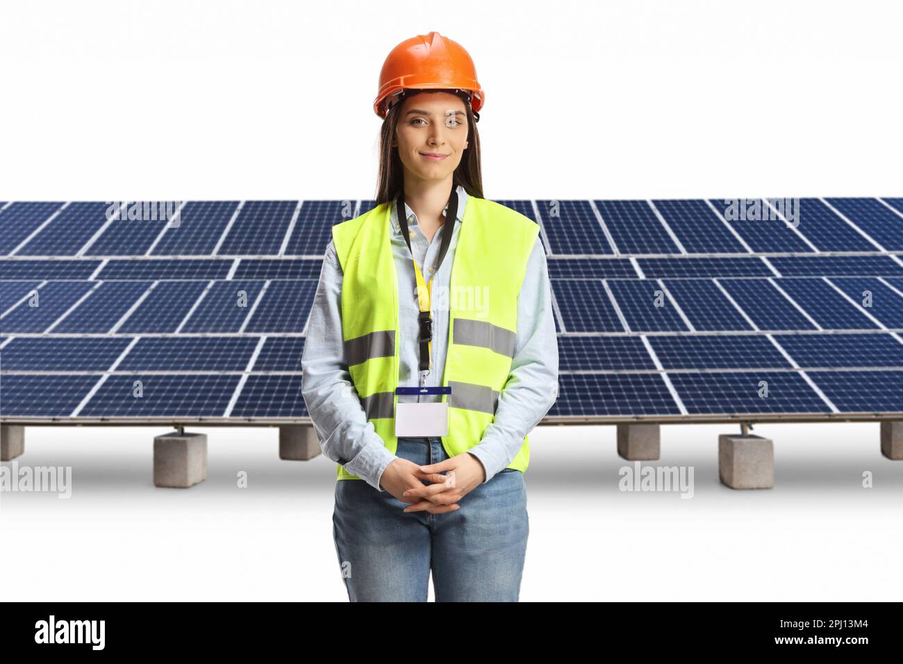 Young female engineer with a safety vest and hardhat standing in front ...