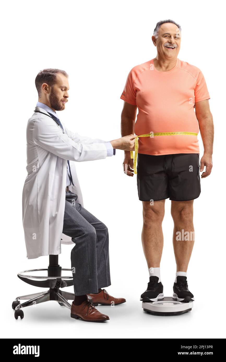 Doctor measuring a mature male patient in a sportswear isolated on ...