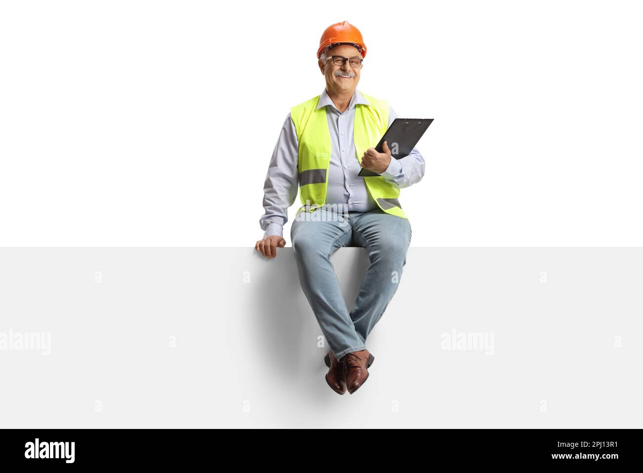 Full length portrait of a mature male engineer sitting ona blank panel ...