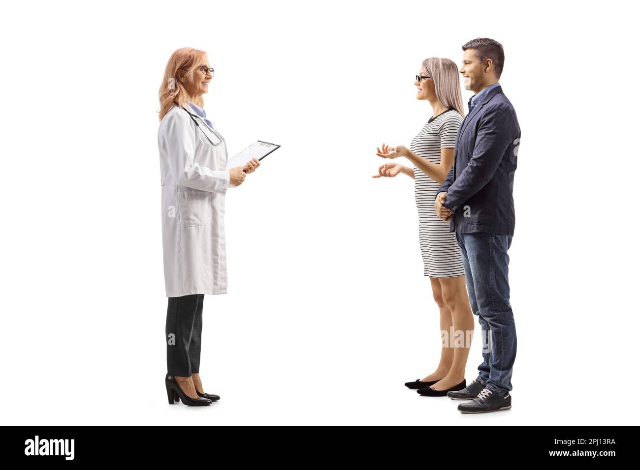 Full length profile shot of a young couple standing and talking to a ...