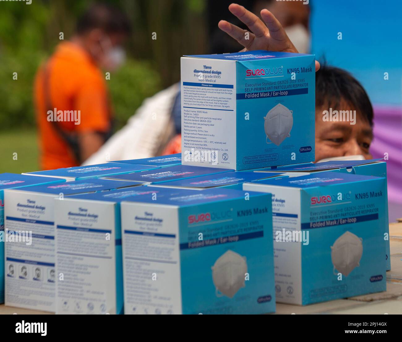 A worker from Chiang Mai Municipality prepares to carry KN95 facial ...