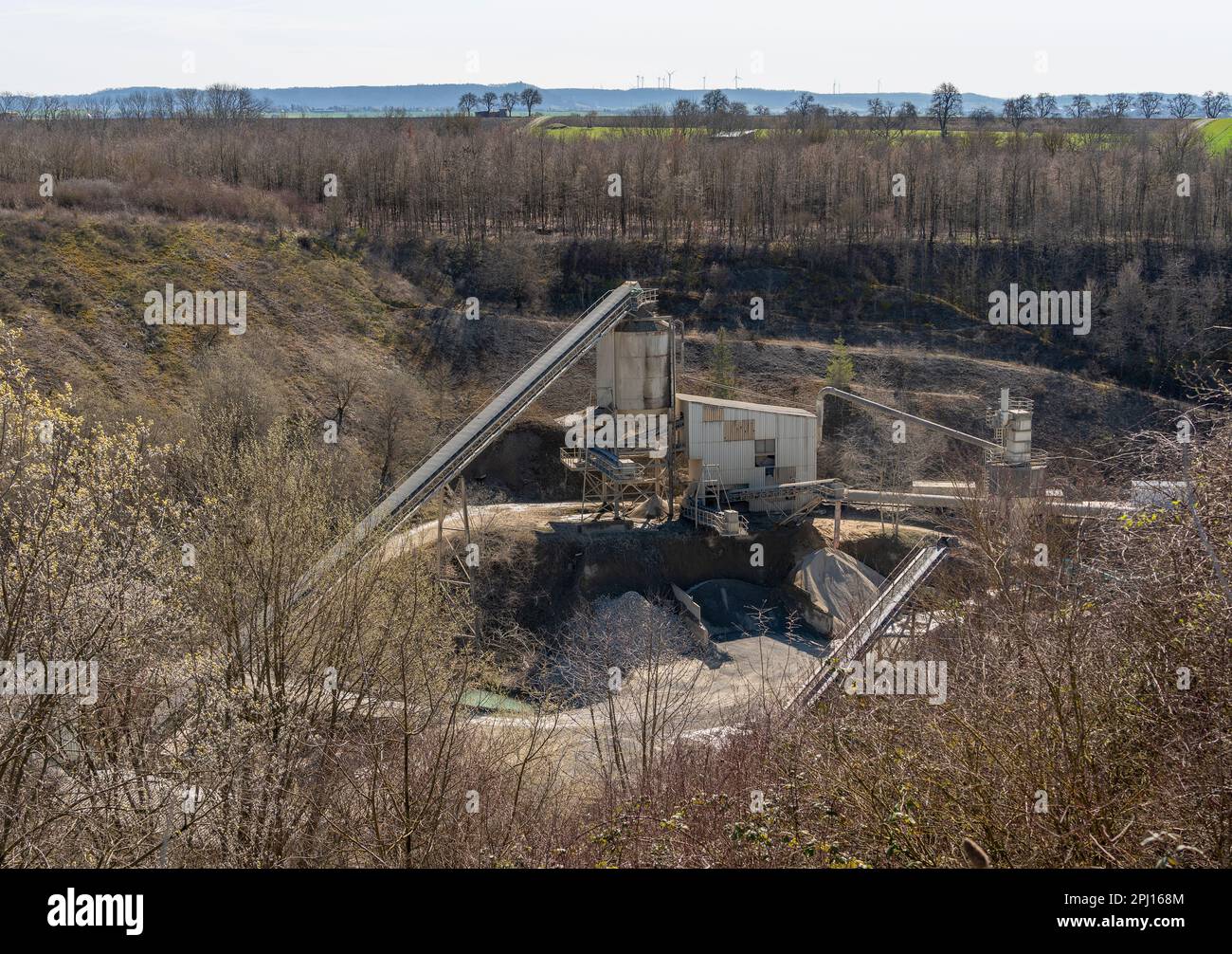 High angle shot of a stone processing plant at a open-pit mine in sunny ...