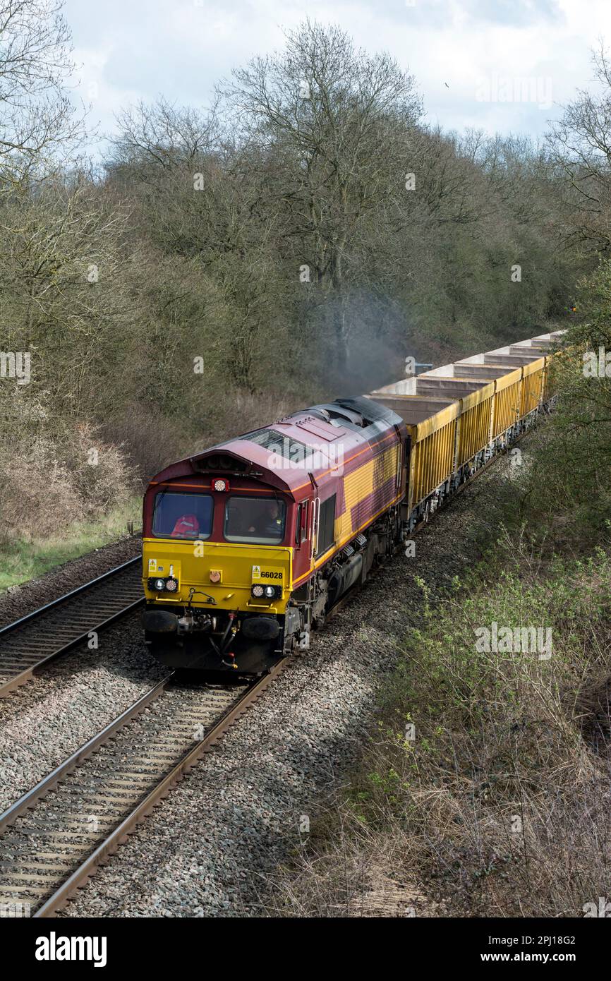 Class 66 diesel locomotive No. 66028 pulling Network Rail wagons at Shrewley, Warwickshire, UK ...