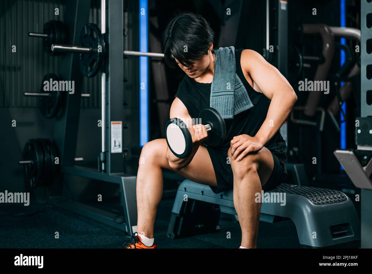 Young man bodybuilder lifting heavy weights dumbbell workout at gym ...