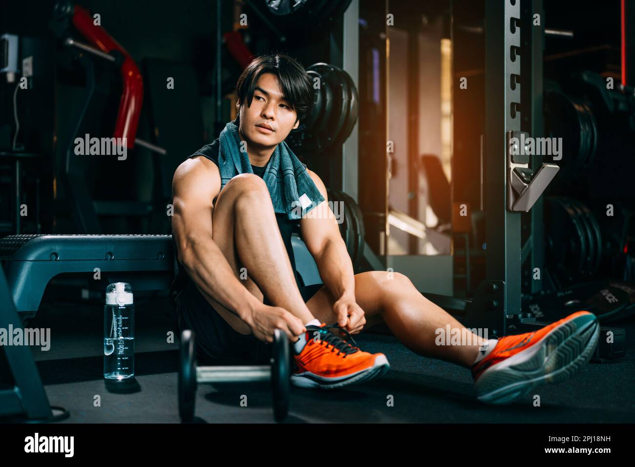 Healthy young man relaxing after exercises workout in fitness gym Stock ...
