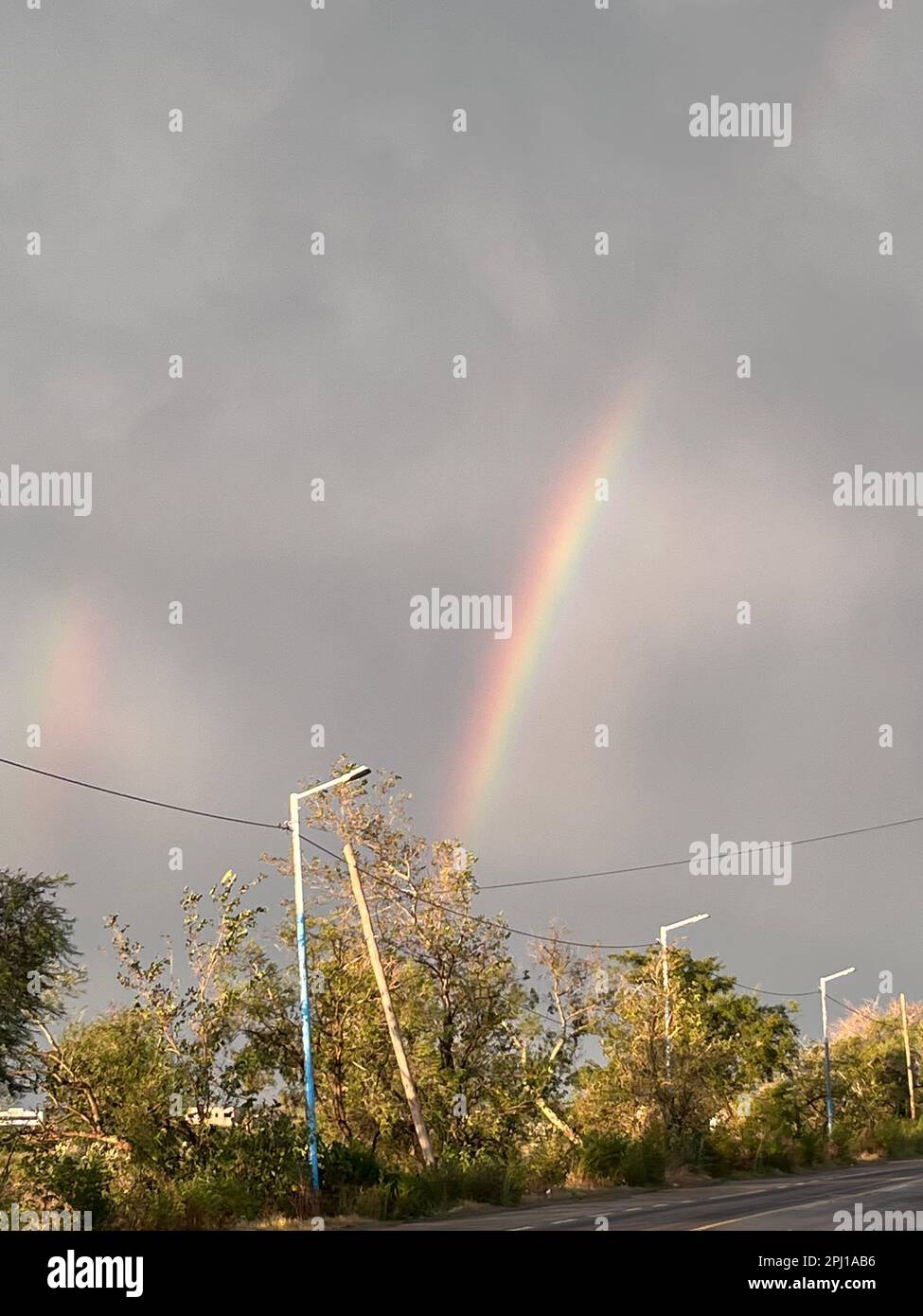 colorful rainbow after summer storm Stock Photo - Alamy