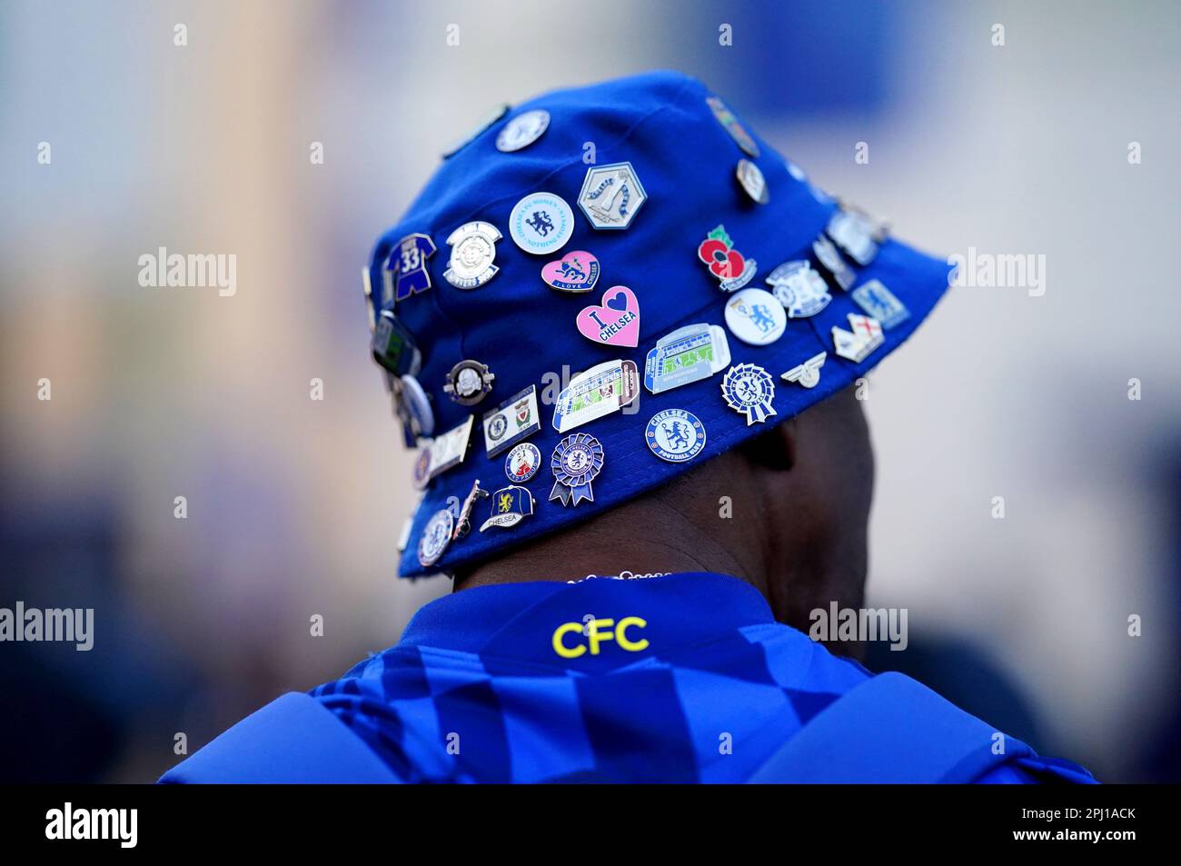 A Chelsea fan wearing a hat covered in badges arrives ahead of the UEFA ...