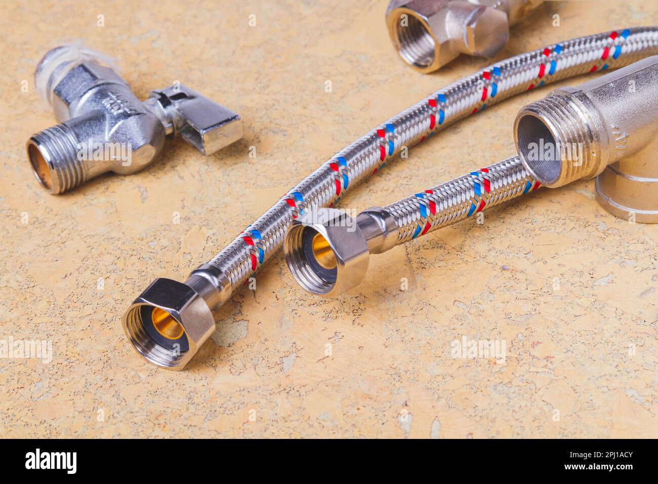 A water tap and a hose in a metal braid. Accessories for the repair of ...