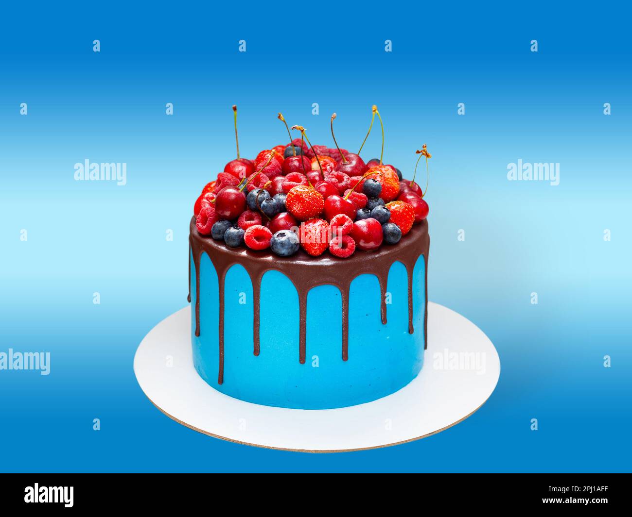 Beautiful blue birthday cake decorated with fresh berries with a place ...