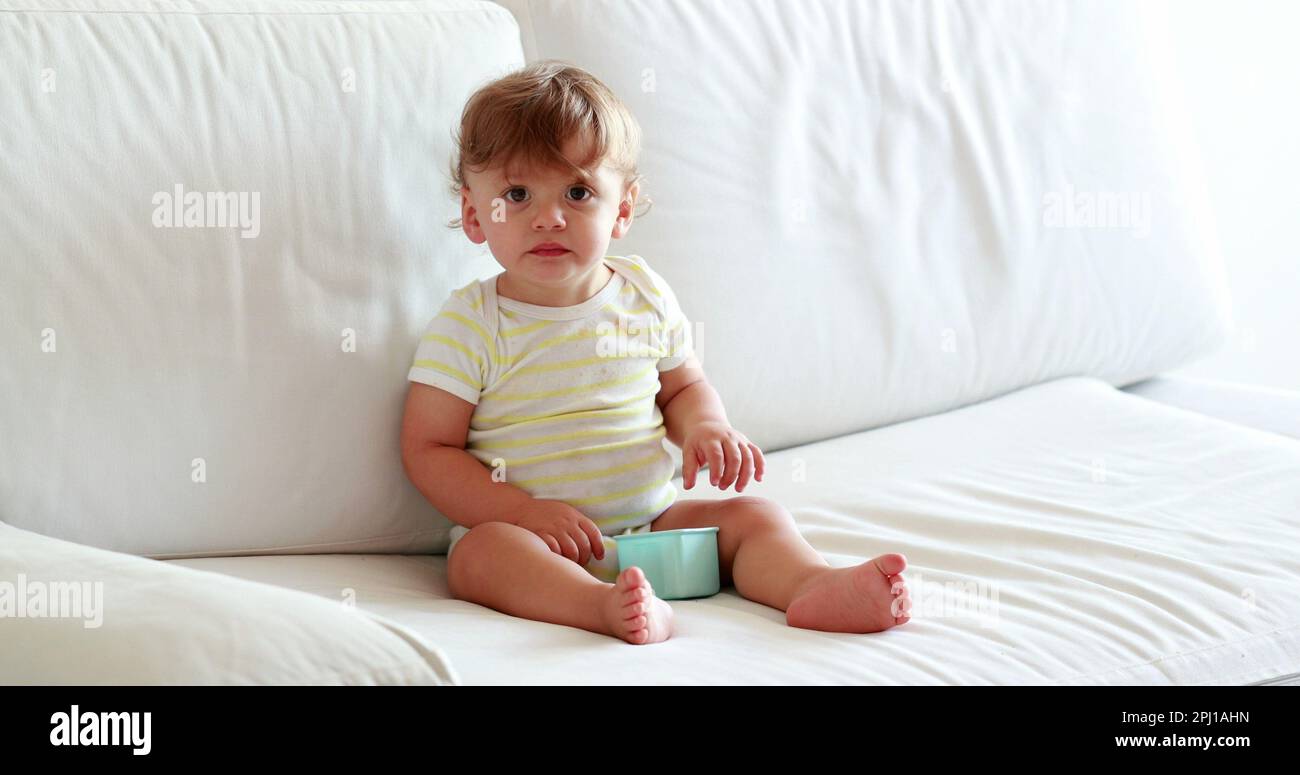 One year old baby toddler boy sitting on sofa coughing, sweet adorable infant child Stock Photo ...