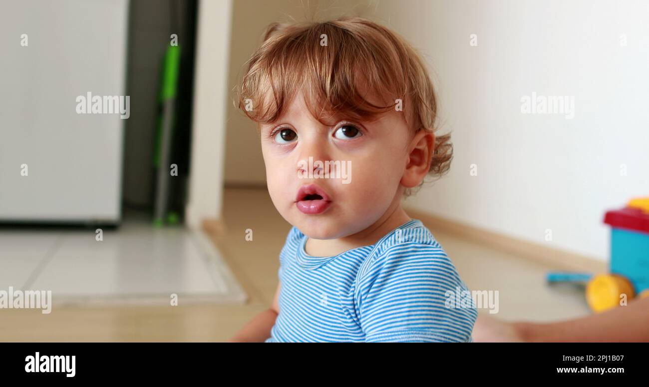 One year old infant baby boy throwing object away, child playing ...