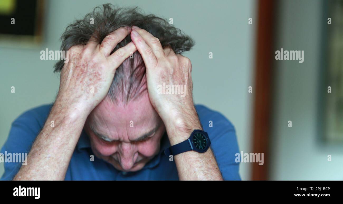 Older man covering face with hands, stressed and tired senior man in ...