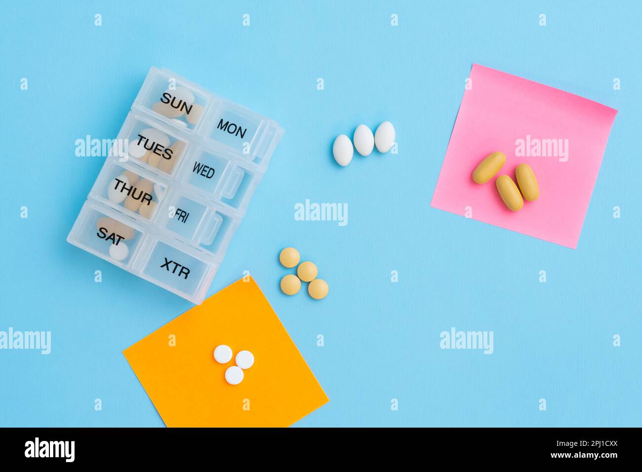 Tablets from the weekly organizer laid out on multi-colored stickers ...