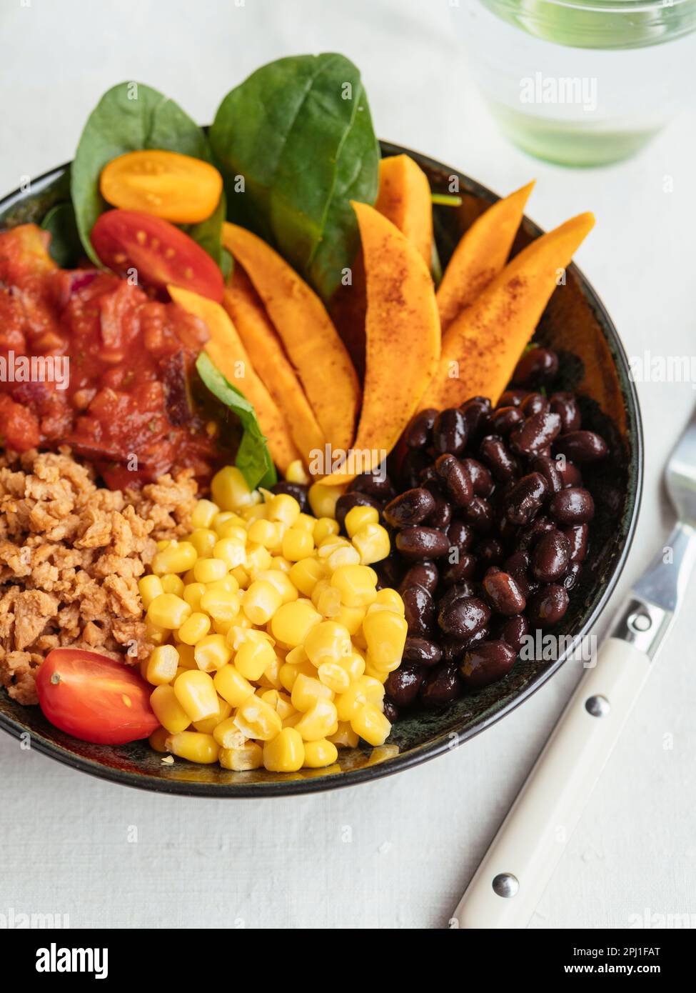 Sweet potato salad bowl with spinach, TVP, corn, black beans, tomato ...