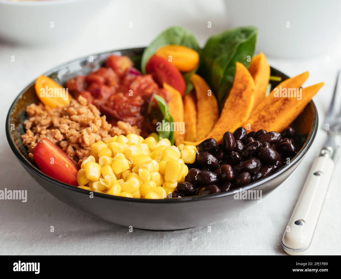 Sweet potato salad bowl with spinach, TVP, corn, black beans, tomato ...